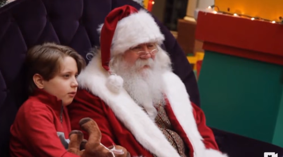 Caring Santa Claus Comforts Shy Boy With Autism
